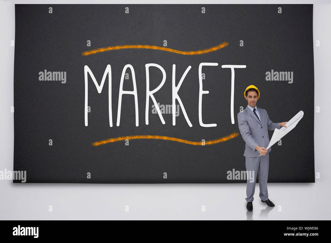 Architect standing against the word market Stock Photo - Alamy