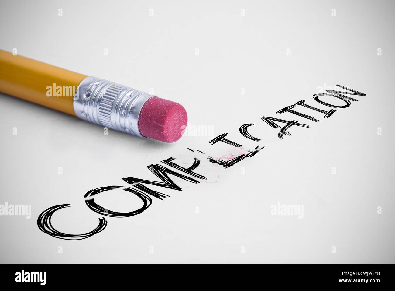 The word complication against pencil with an eraser Stock Photo - Alamy