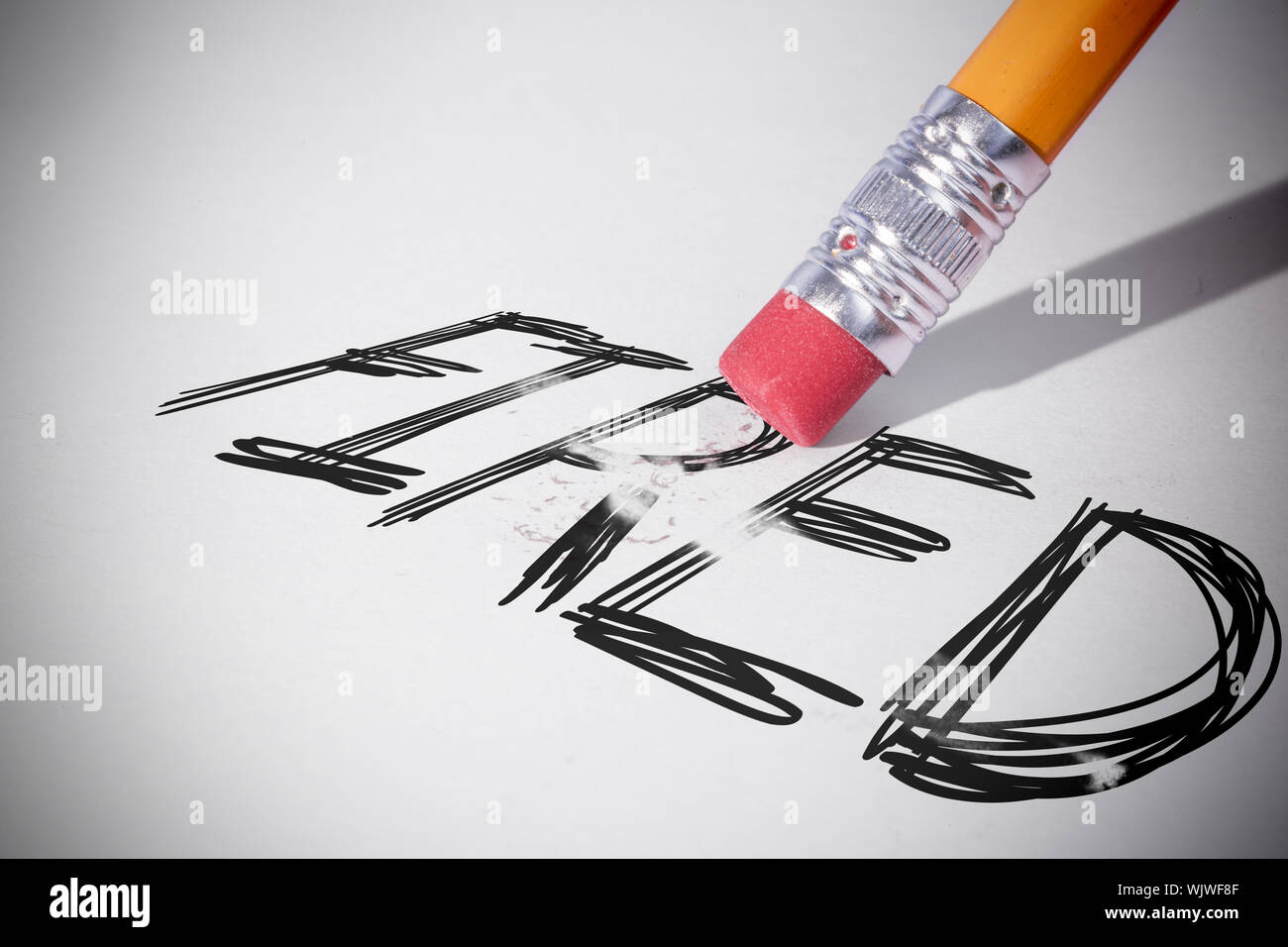 Pencil erasing the word fired on paper Stock Photo - Alamy