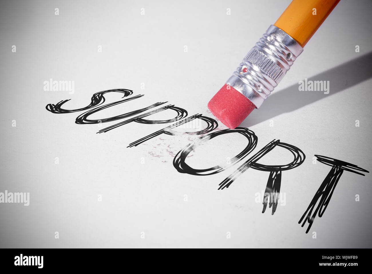 Pencil erasing the word support on paper Stock Photo - Alamy