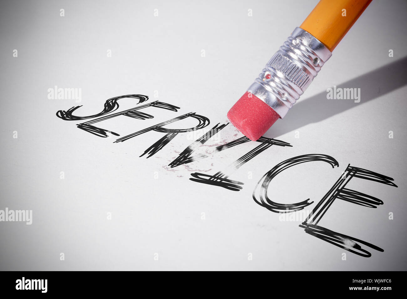 Pencil erasing the word service on paper Stock Photo - Alamy