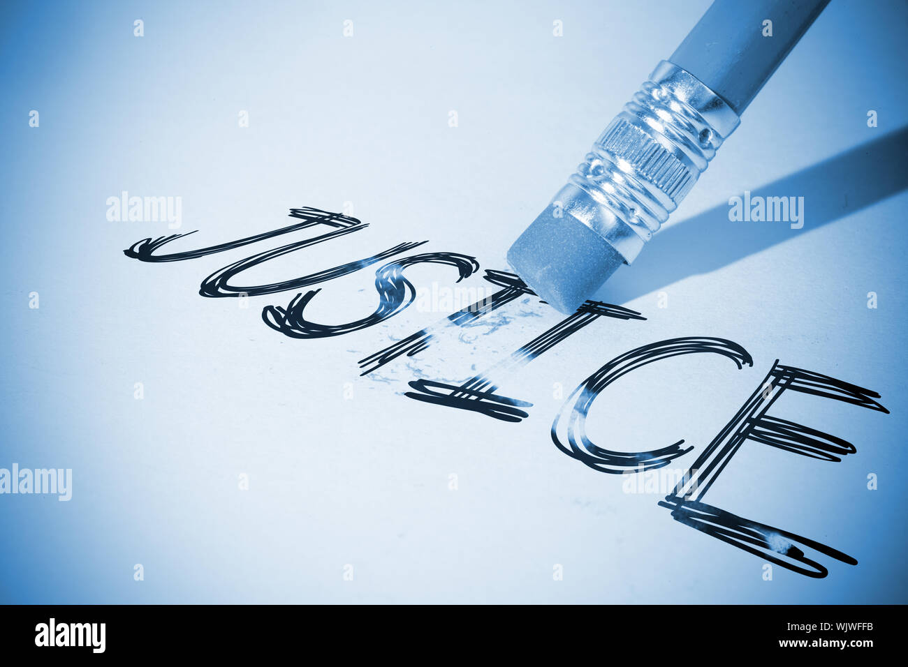 Pencil erasing the word justice on paper Stock Photo - Alamy