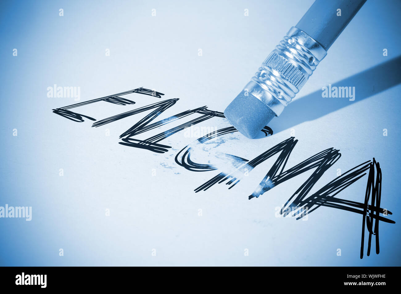 Pencil erasing the word enigma on paper Stock Photo - Alamy