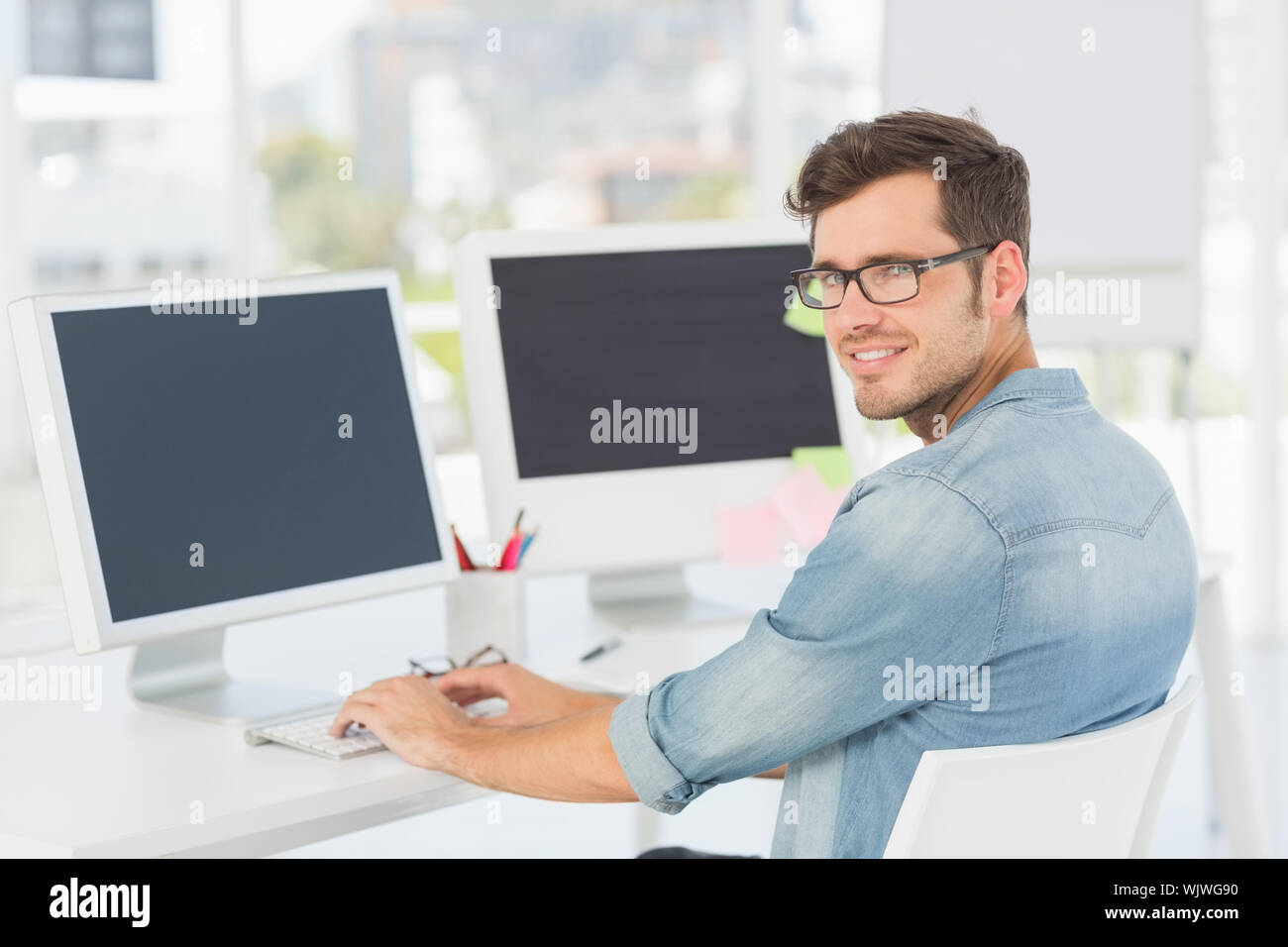 Side view portrait of a male artist using computer in the office Stock ...