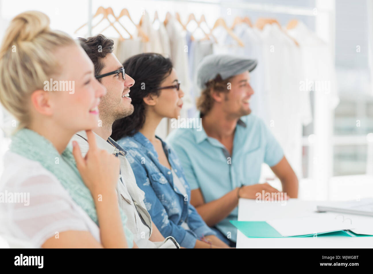 Group of fashion designers discussing designs in a studio Stock Photo ...