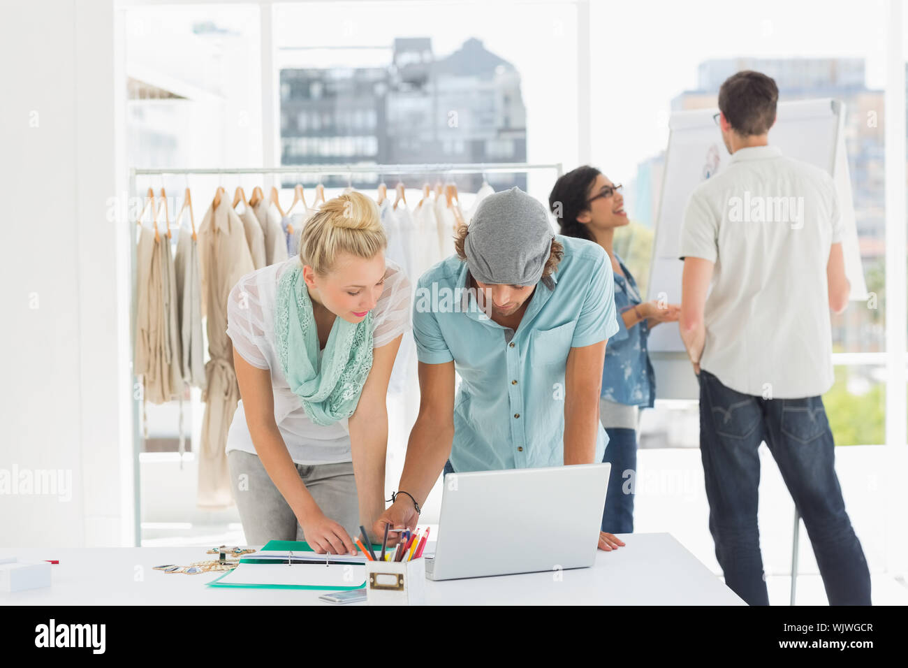 Group of fashion designers at work in a studio Stock Photo - Alamy