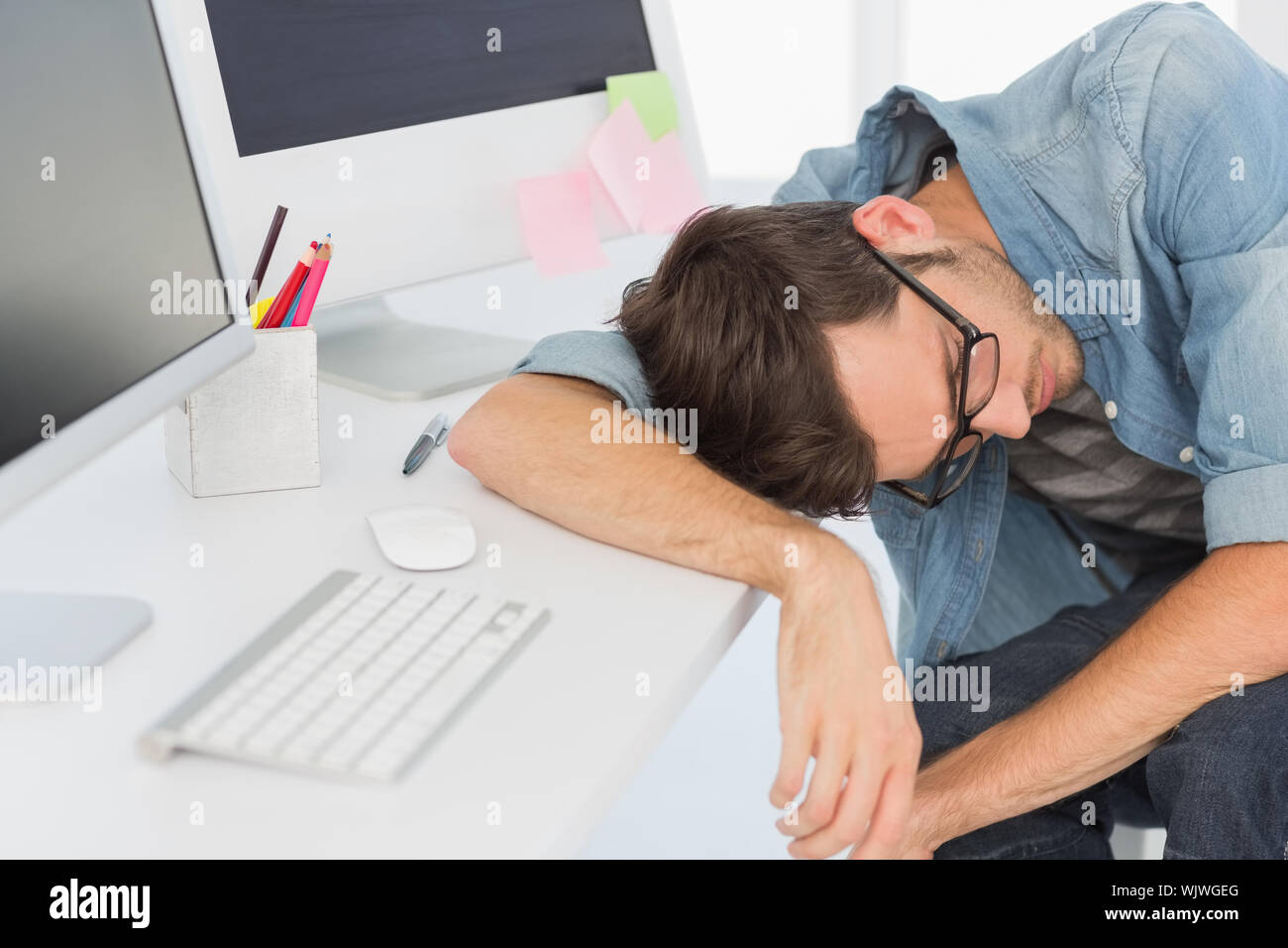 Tired creative man sleeping work hi-res stock photography and images ...