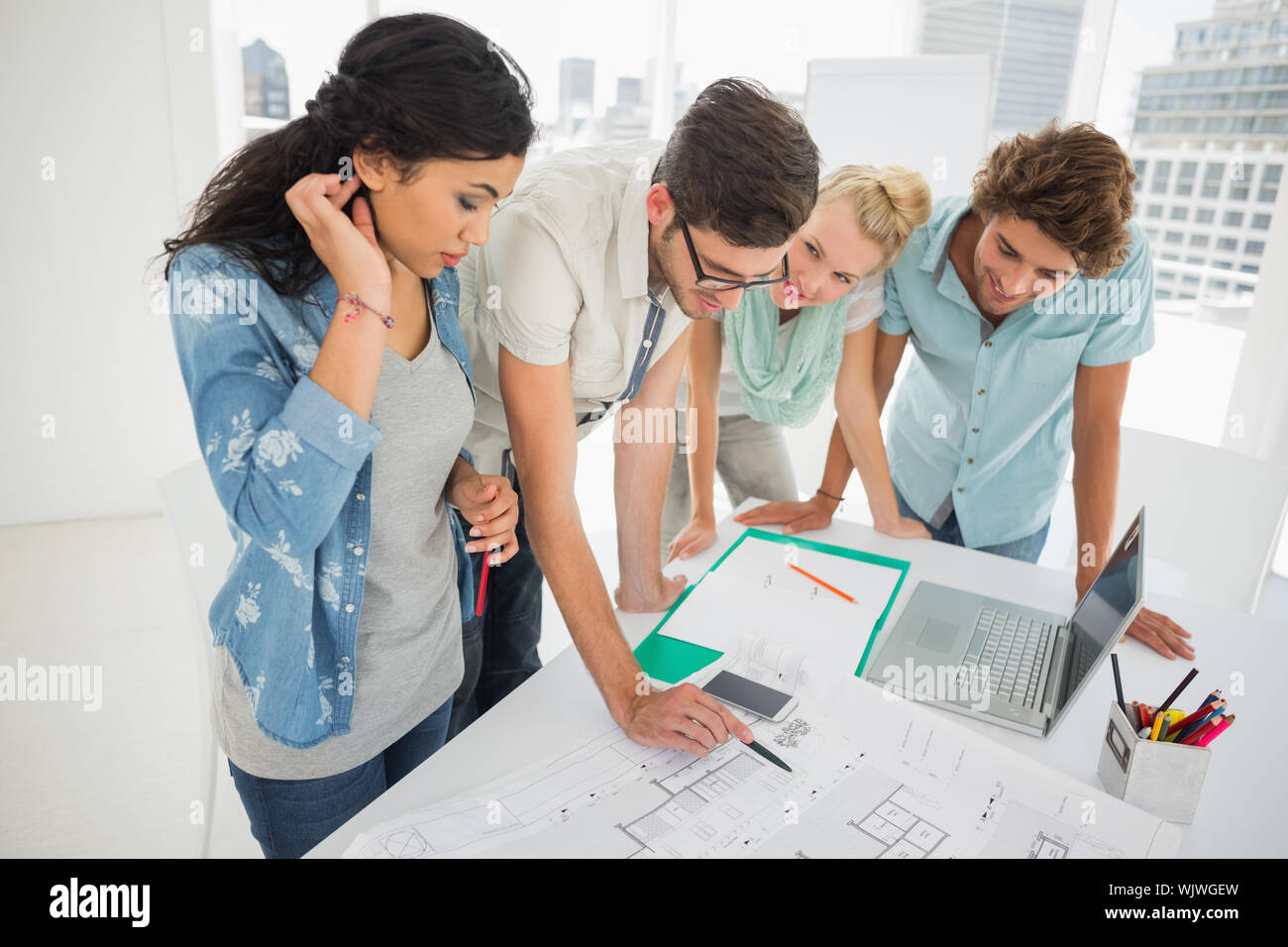 Group of fashion designers discussing designs in a studio Stock Photo ...