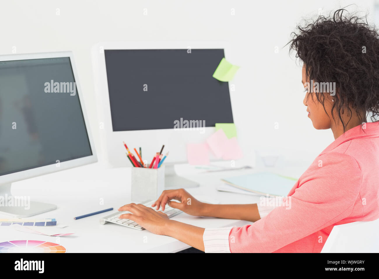 Side view of a female artist using computer in the office Stock Photo ...