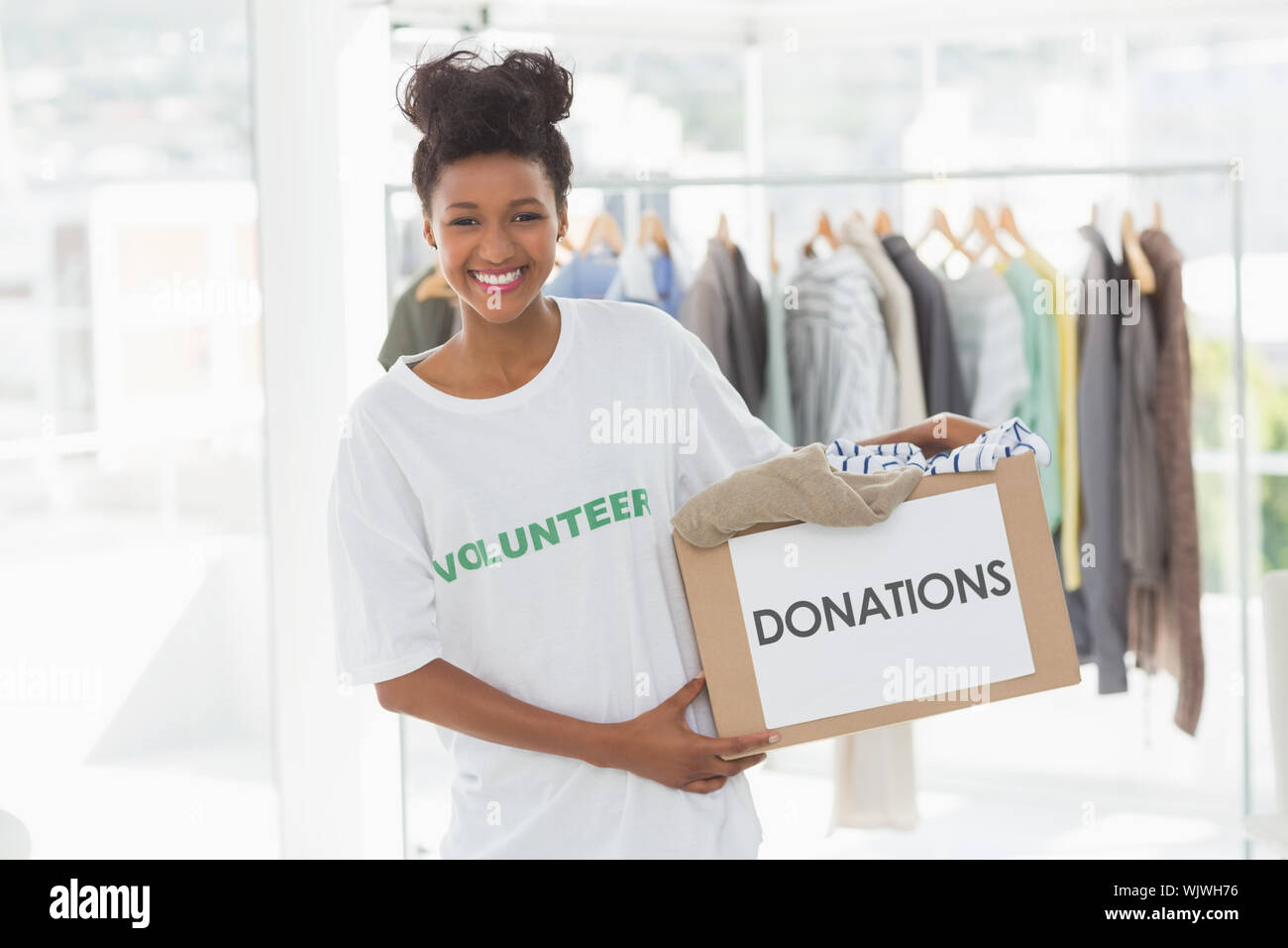 Beautiful woman donating clothes hi-res stock photography and images ...