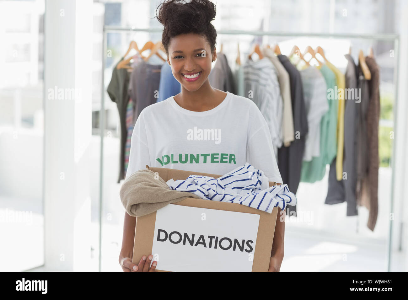 Beautiful woman donating clothes hi-res stock photography and images ...