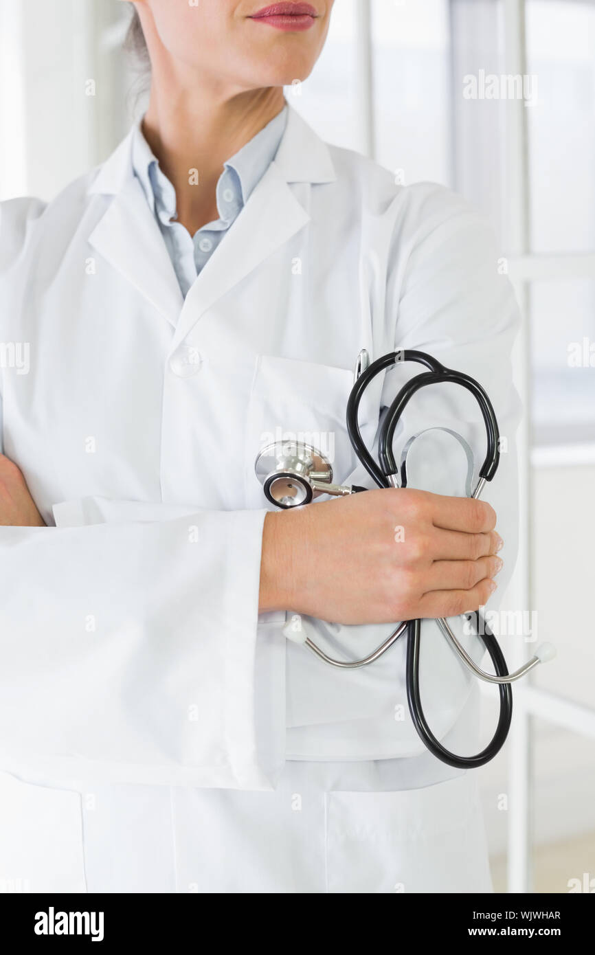 Closeup mid section of a female doctor standing with stethoscope in the ...