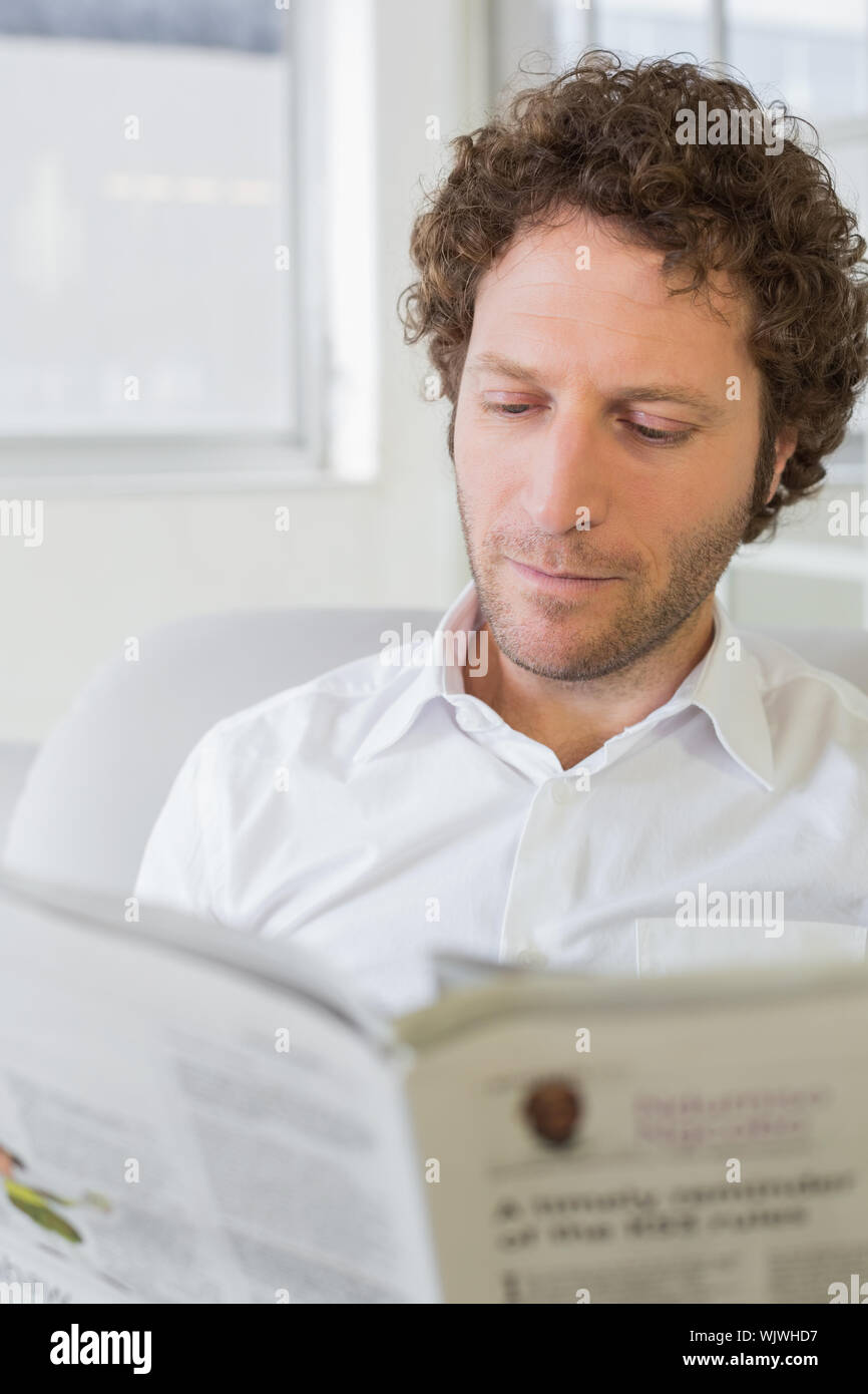 Young man reading newspaper 30s hi-res stock photography and images - Alamy