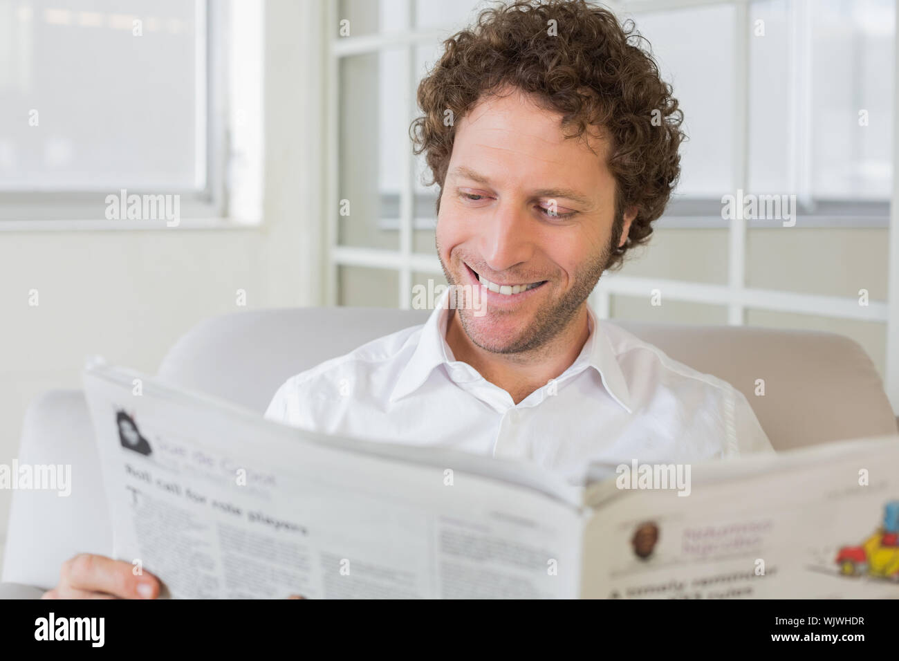 Young man reading newspaper 30s hi-res stock photography and images - Alamy