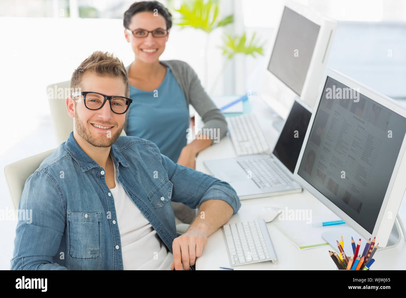 Attractive creative team looking camera hi-res stock photography and ...