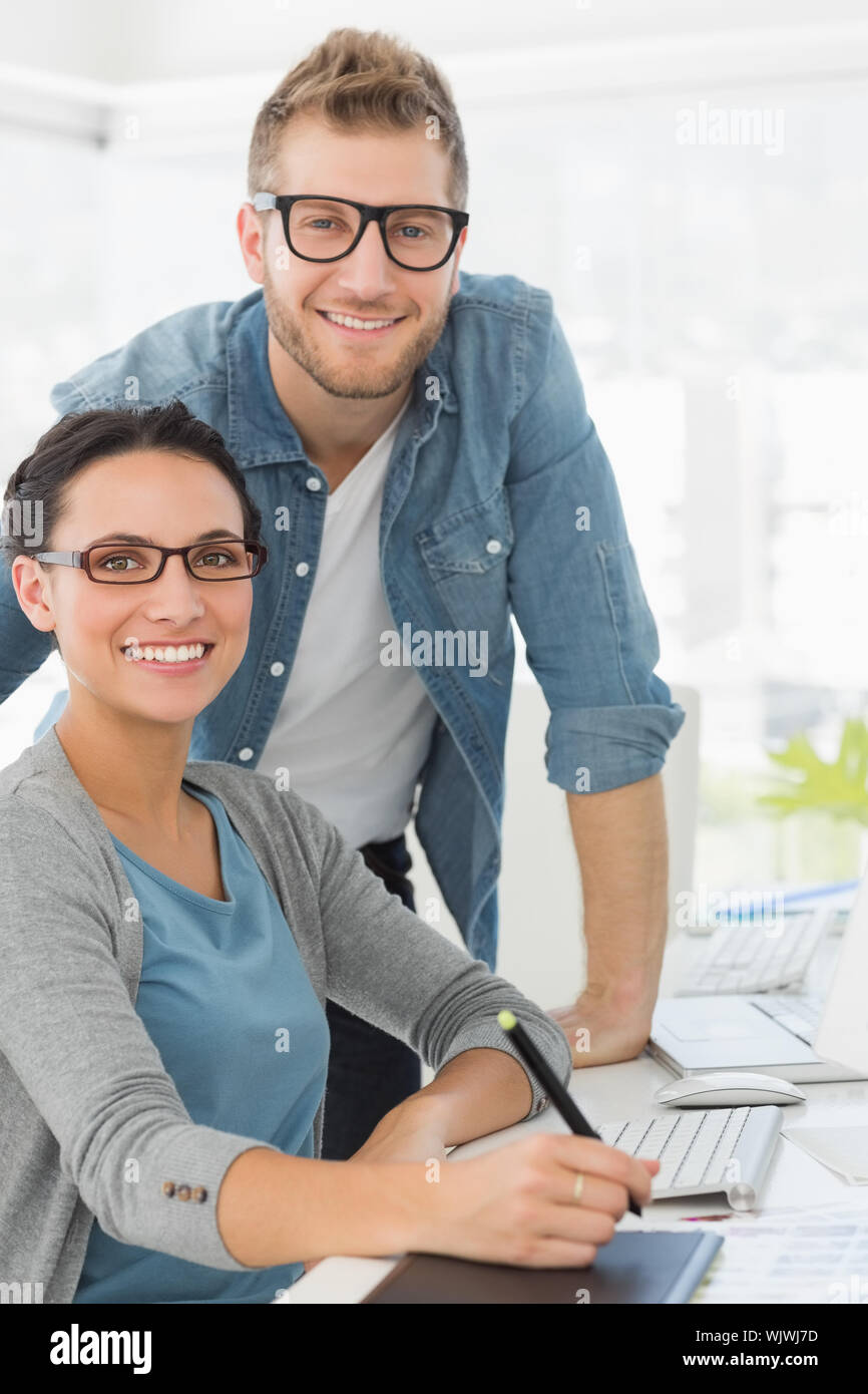 Attractive creative team smiling camera hi-res stock photography and ...