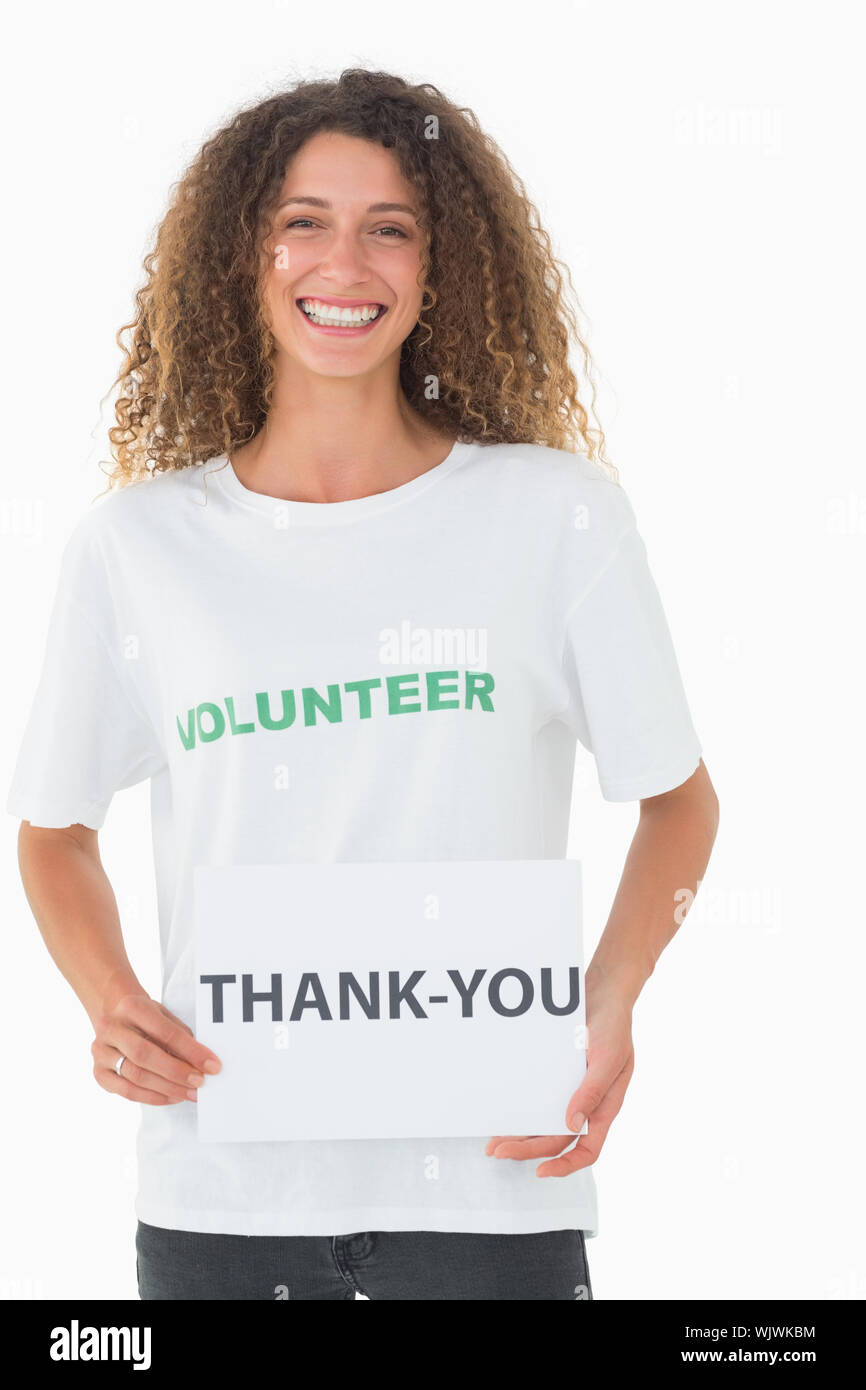Smiling volunteer showing a thank you poster on white background Stock ...