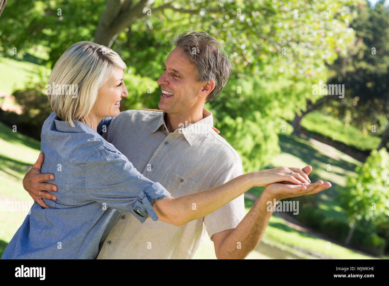 Happy loving couple dancing in park Stock Photo - Alamy
