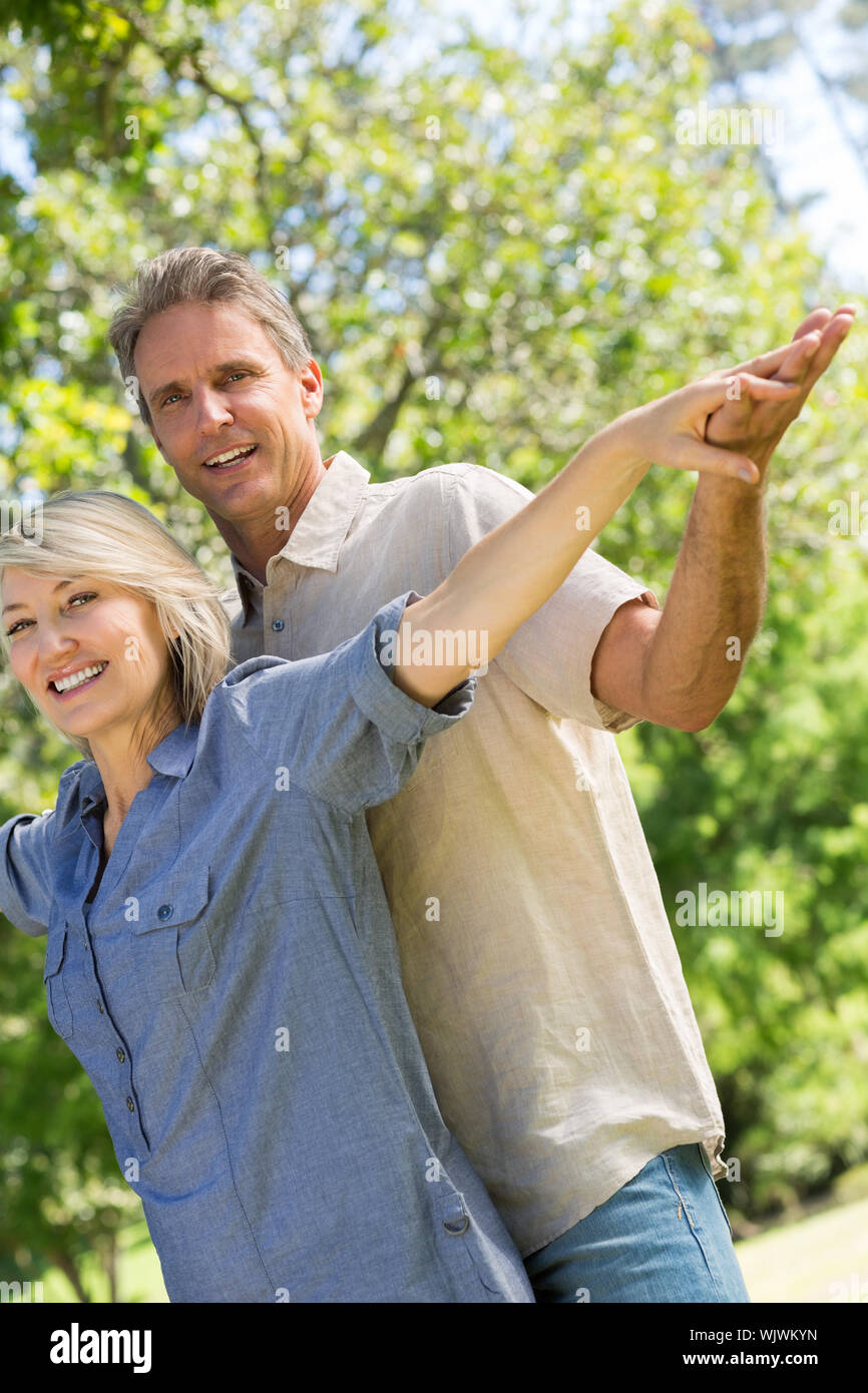Tilt image of romantic couple looking at each other in park Stock Photo ...