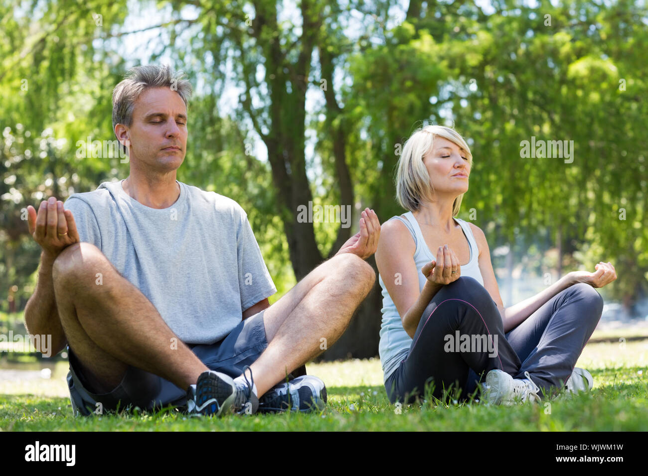 Couple sitting in lotus position hi-res stock photography and images ...