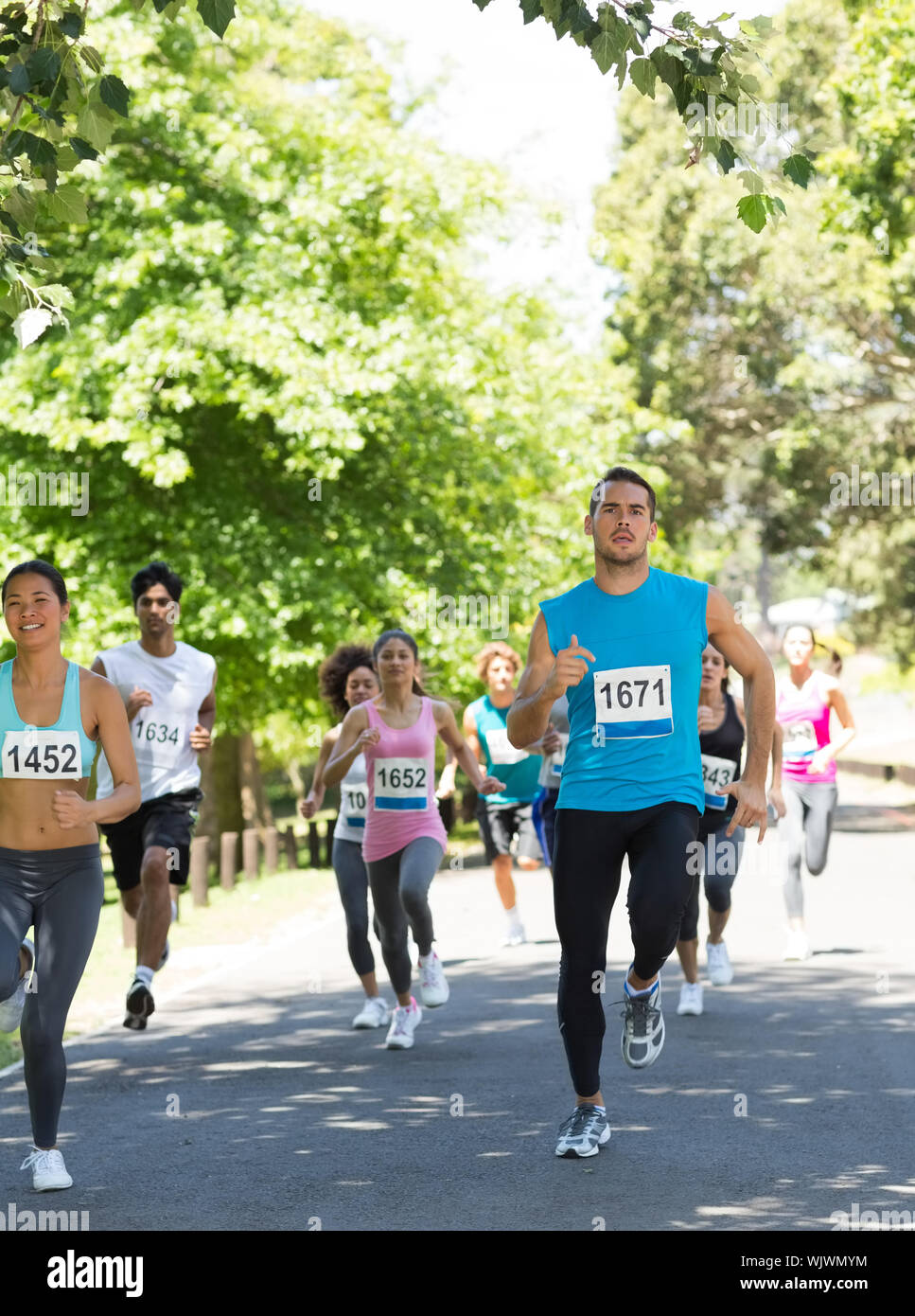 Group of athletes running in marathon on street Stock Photo - Alamy