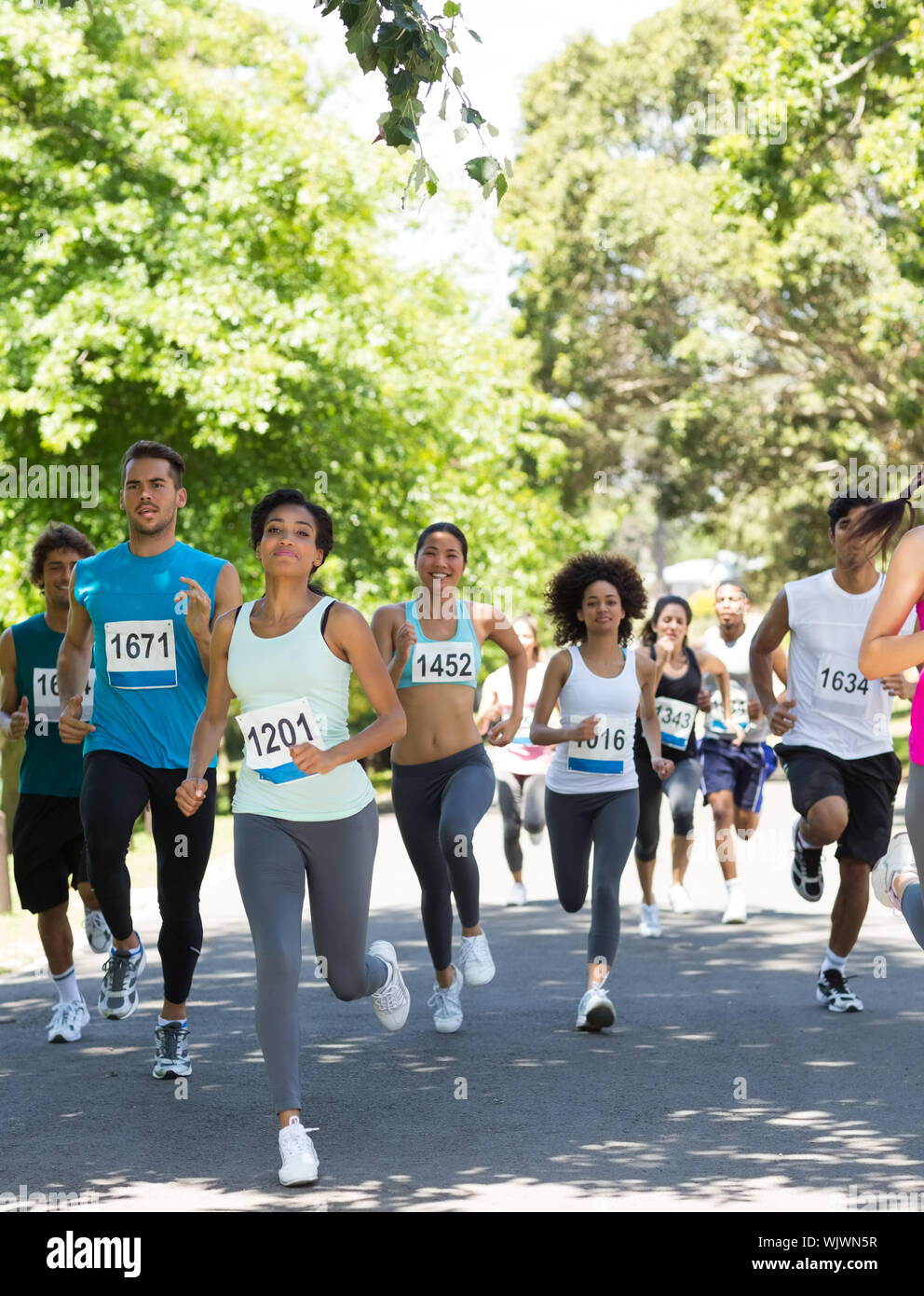 Group of marathon athletes running on street Stock Photo - Alamy