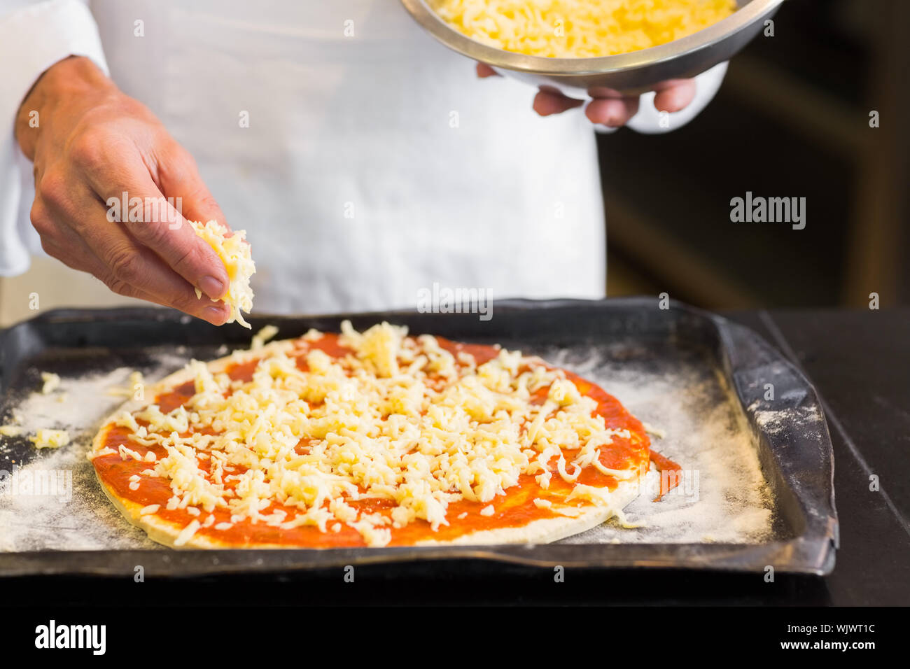 Mid section of a male chef preparing pizza Stock Photo - Alamy