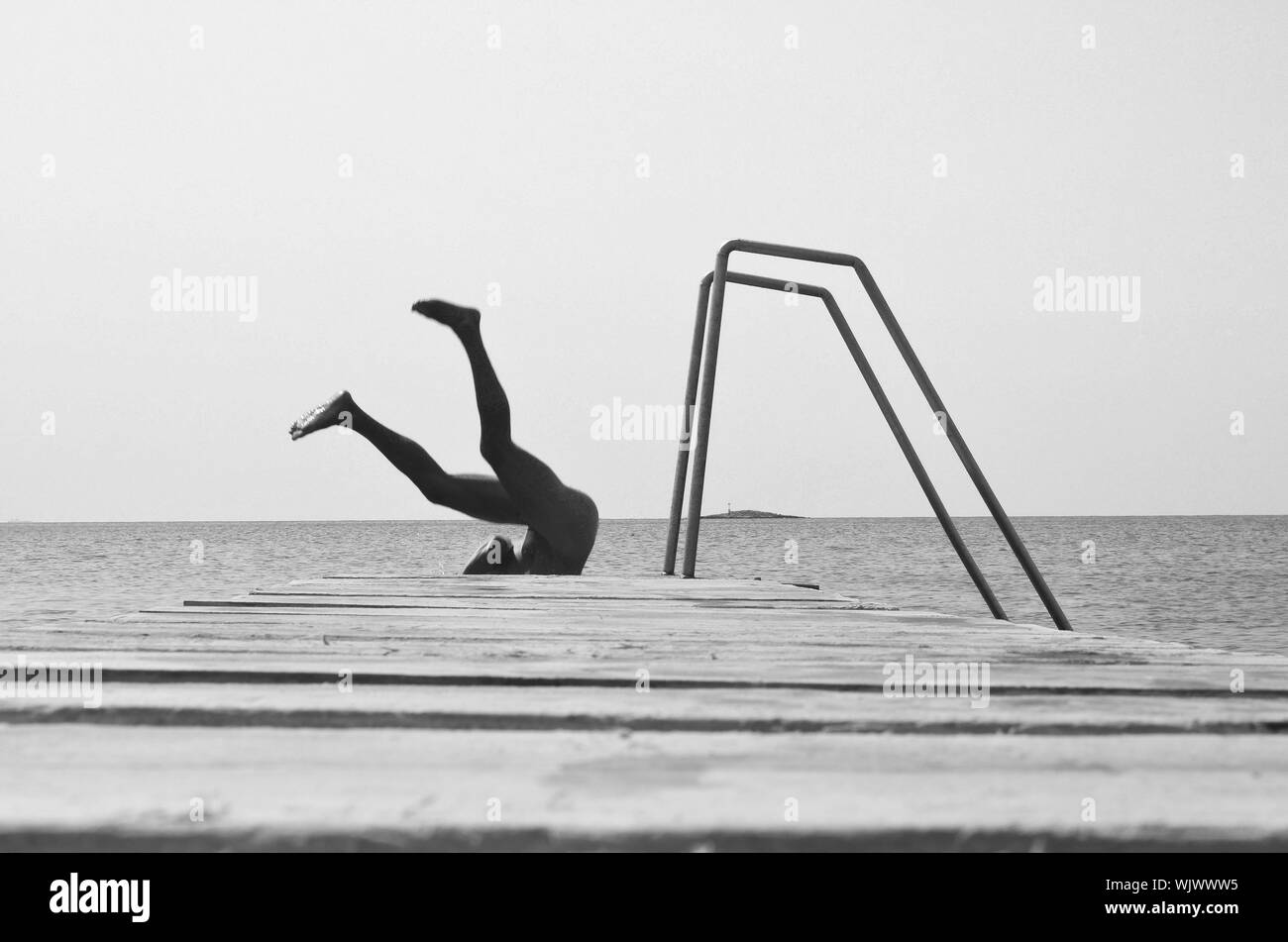 Man Diving Into Water Black and White Stock Photos & Images - Alamy