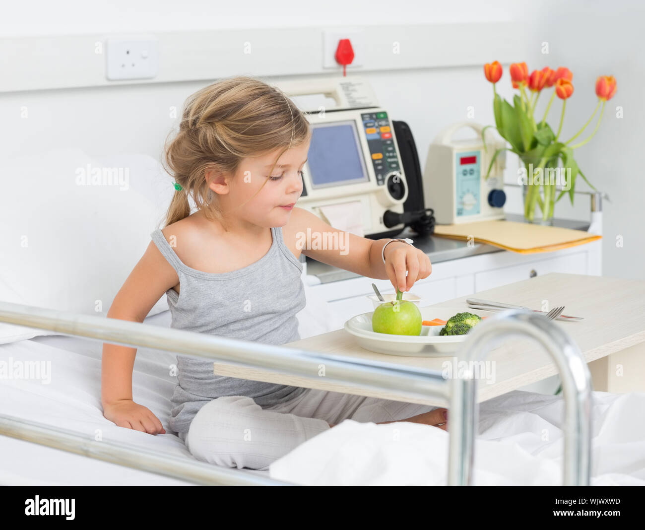 Little girl eating healthy food in hospital bed Stock Photo - Alamy