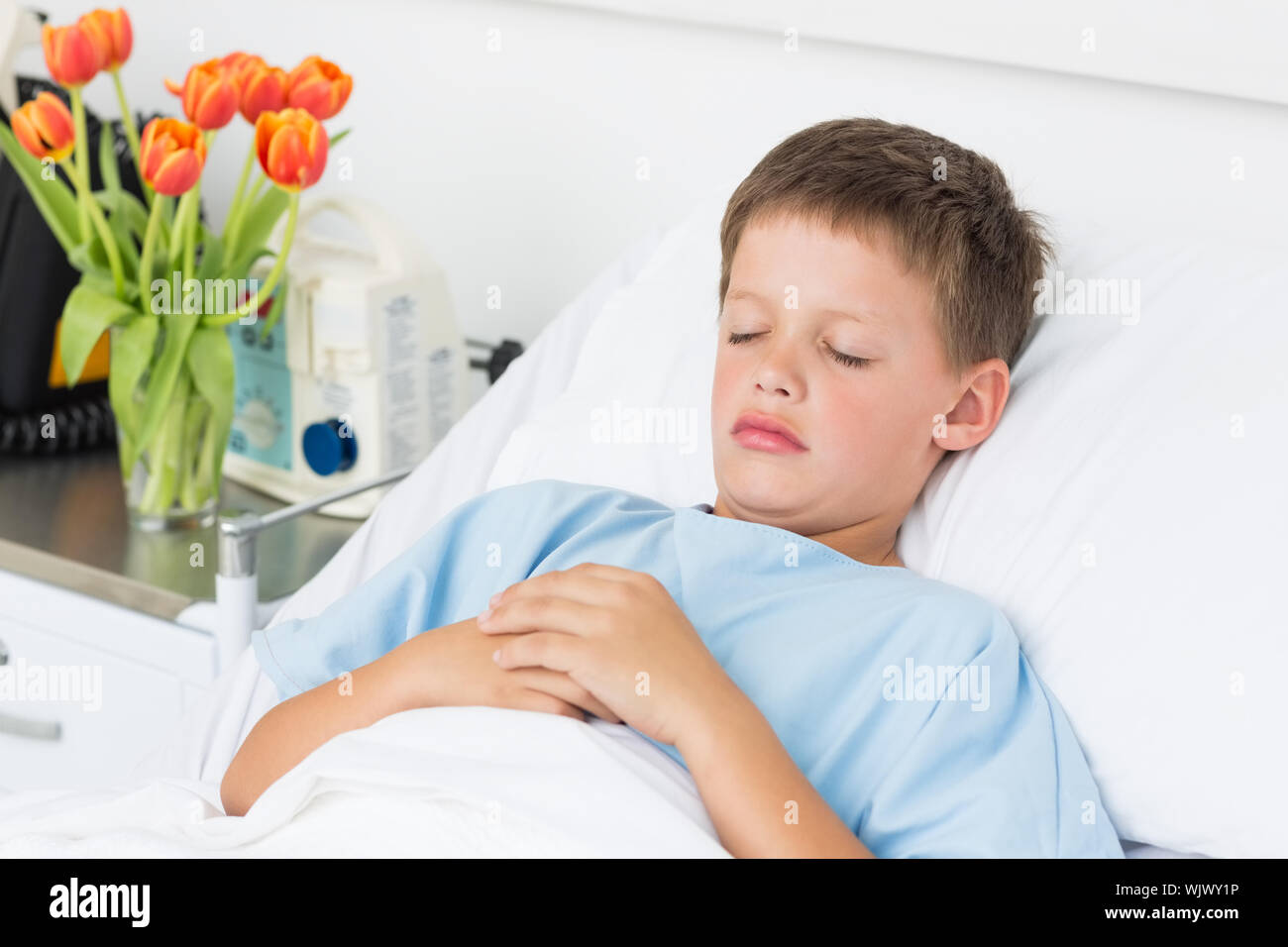 Sick little boy sleeping in hospital bed Stock Photo - Alamy