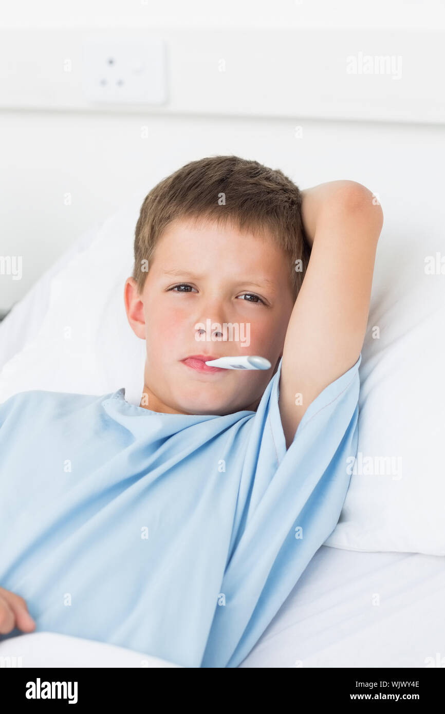 Portrait of sick little boy in hospital with thermometer in mouth Stock ...