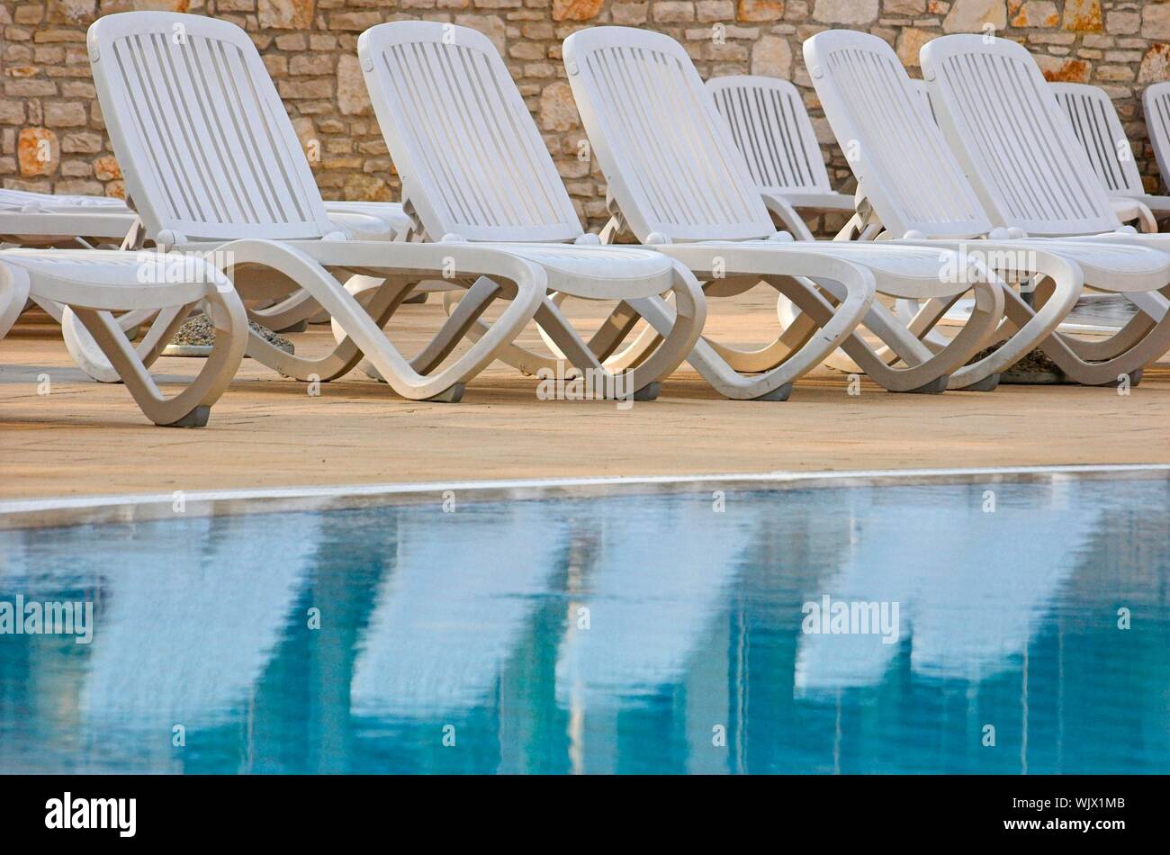Plastic white chairs standing on a swimming pool terrace Stock Photo ...