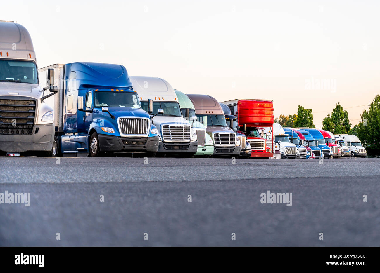 Different make and models big rigs semi trucks with semi trailers ...