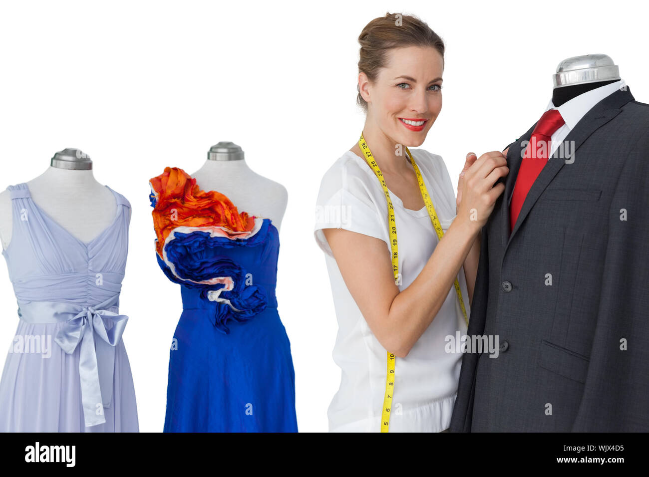 Portrait of a female fashion designer and mannequins isolated on white ...