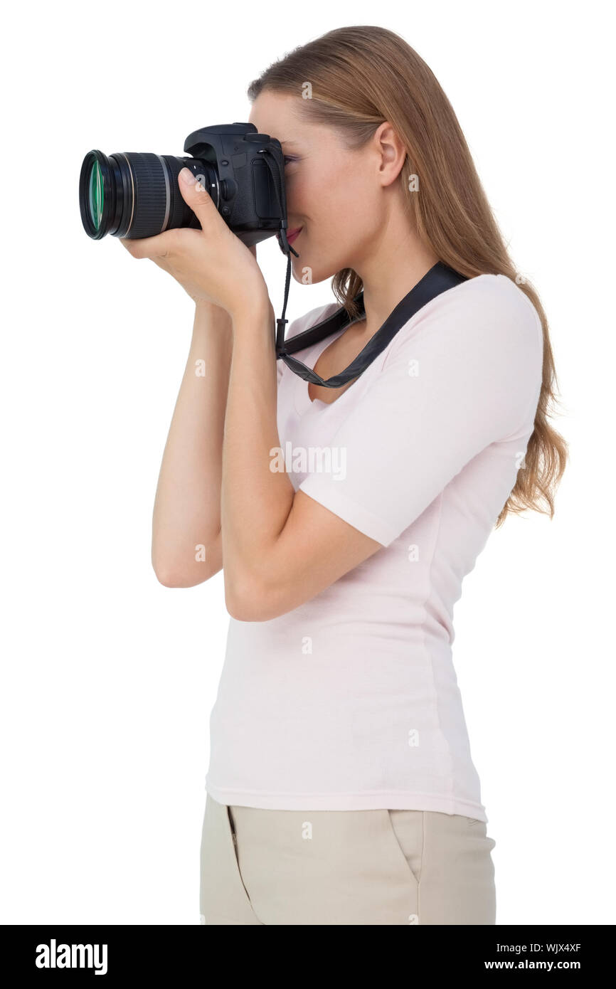 Side view of a young woman with camera over white background Stock ...