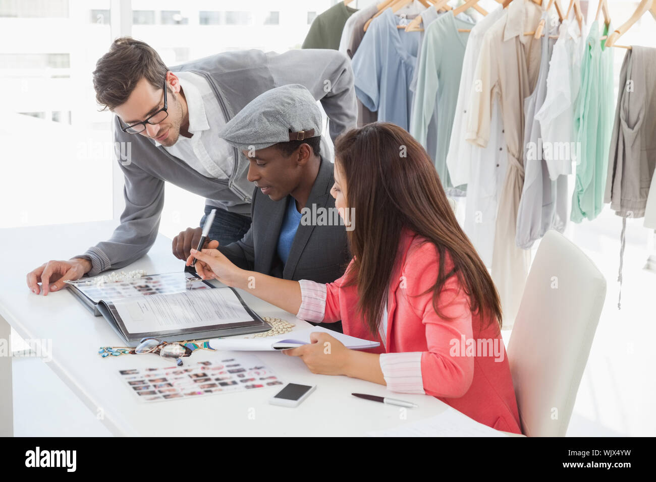 Group of fashion designers discussing designs in a studio Stock Photo ...
