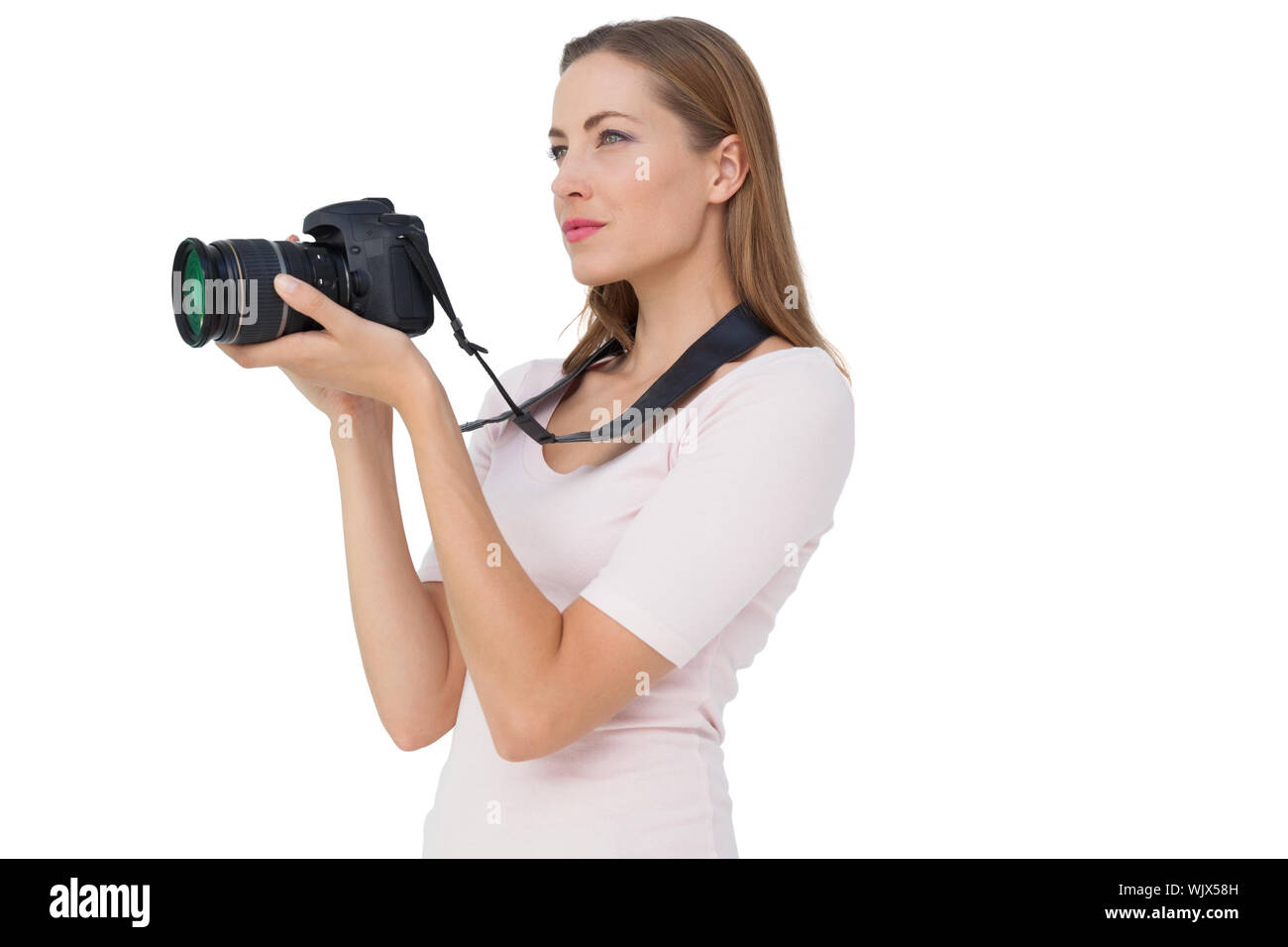 Side view of a young woman with camera over white background Stock ...