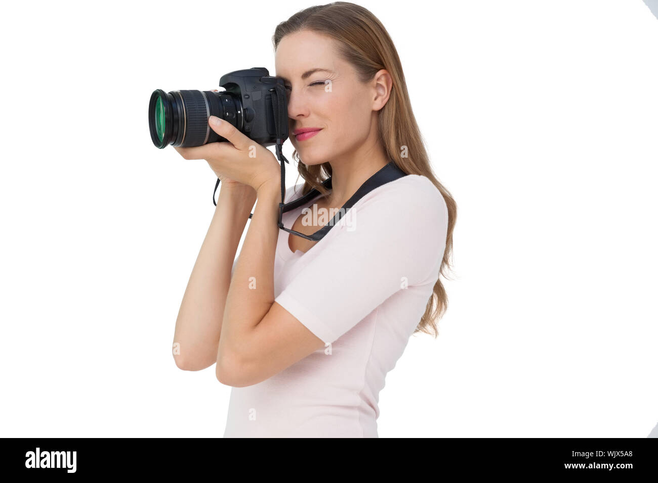 Side view of a young woman with camera over white background Stock ...