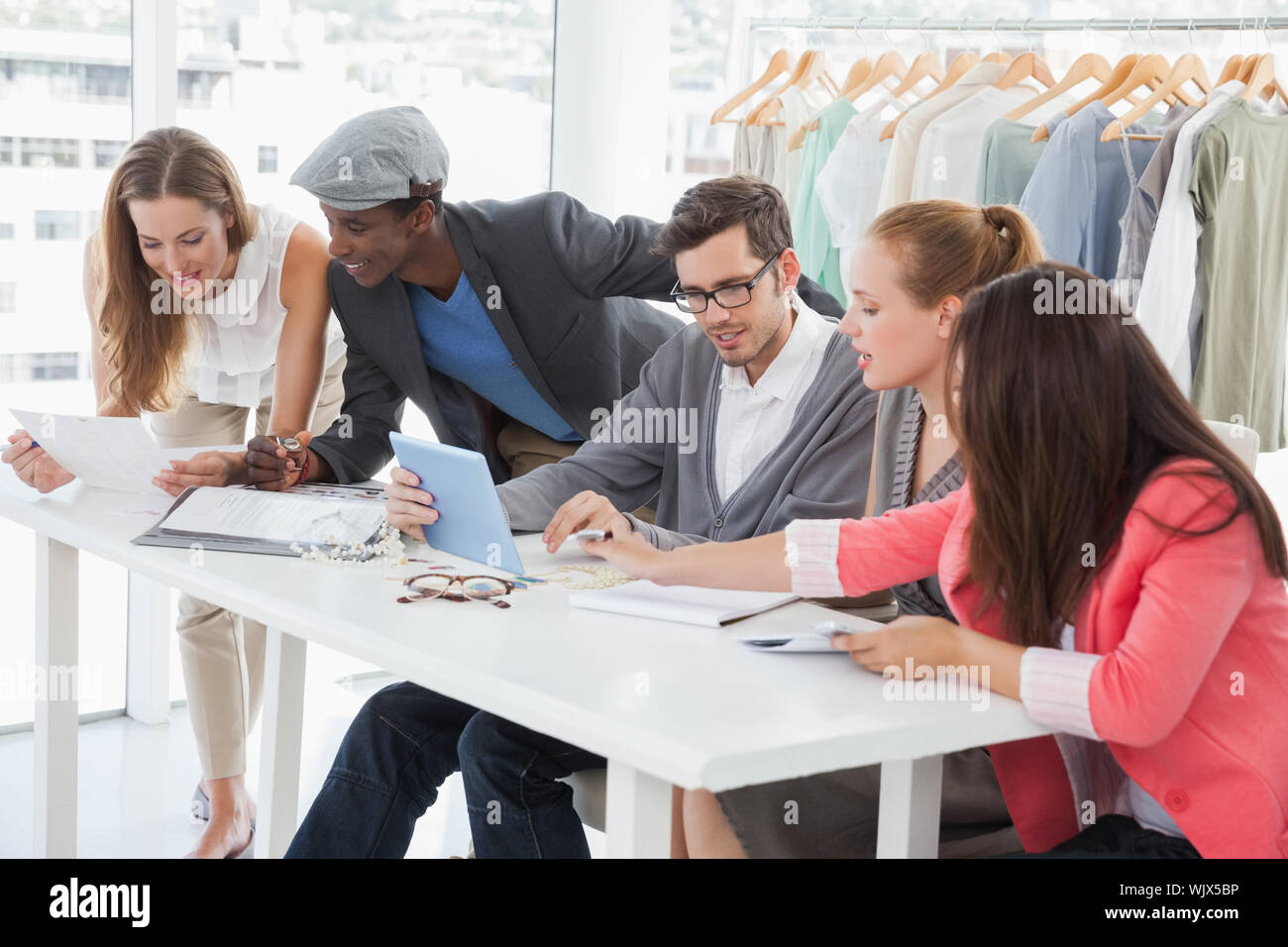 Group of fashion designers discussing designs in a studio Stock Photo ...
