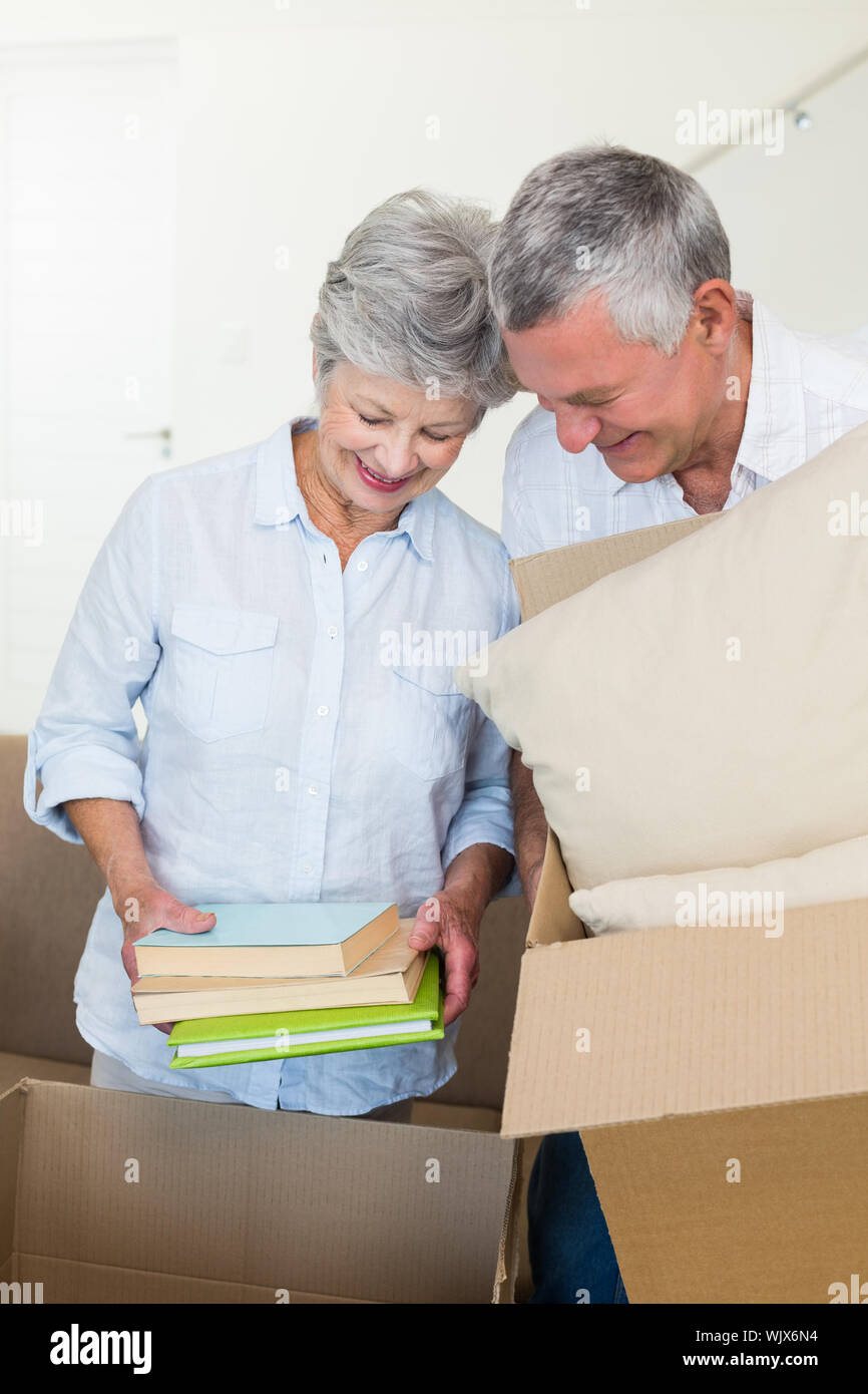 Elderly man unpacking boxes hi-res stock photography and images - Alamy
