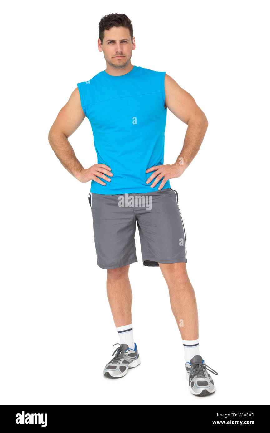 Full length portrait of a fit young man standing over white background ...