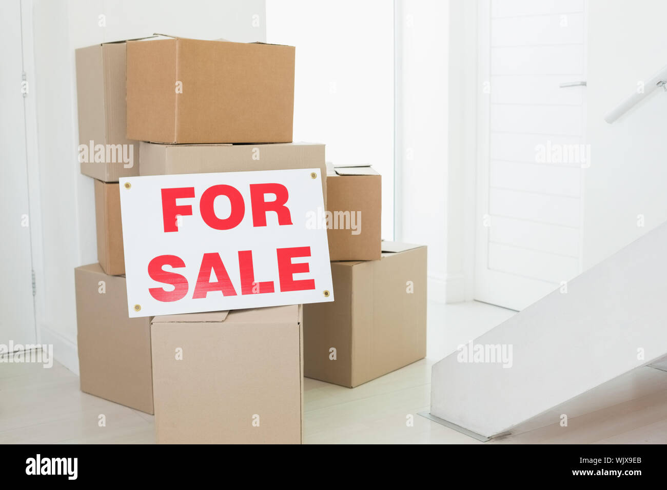 For sale sign with many cardboard boxes in an empty house Stock Photo ...