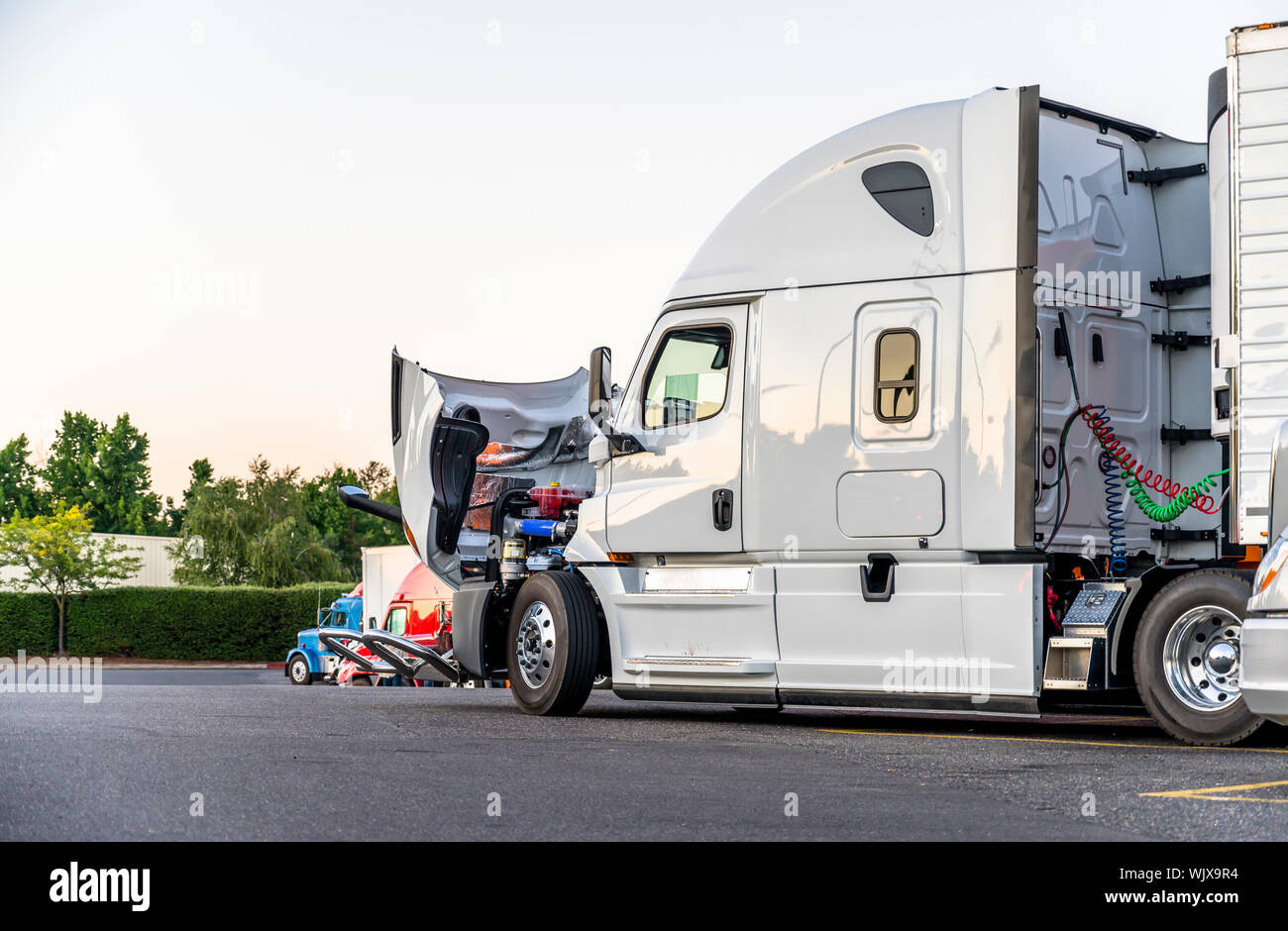 White bonnet big rig semi truck with open hood for engine inspection ...