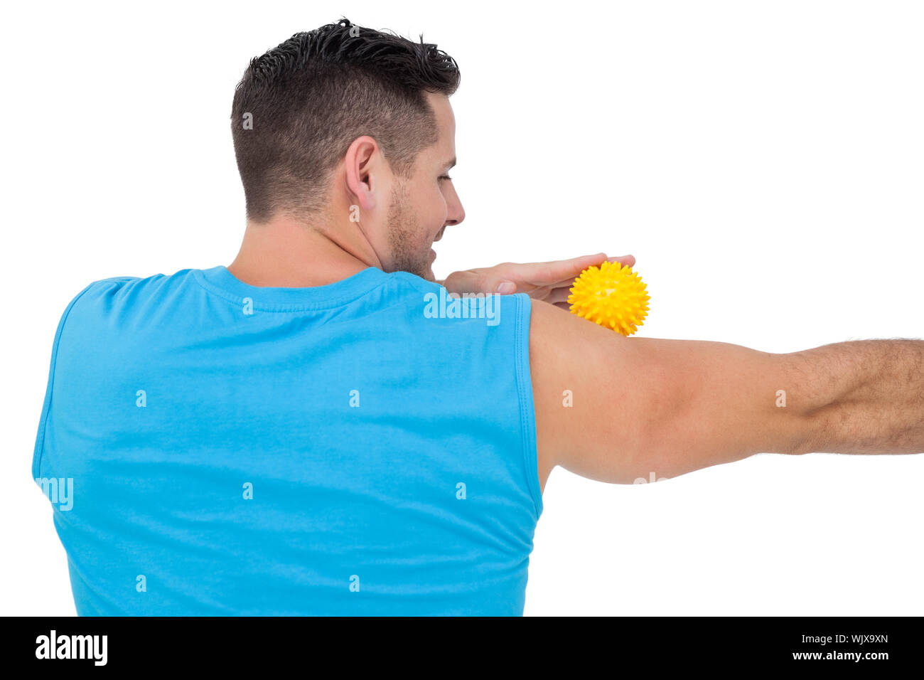 Rear view of a content young man holding stress ball over white ...