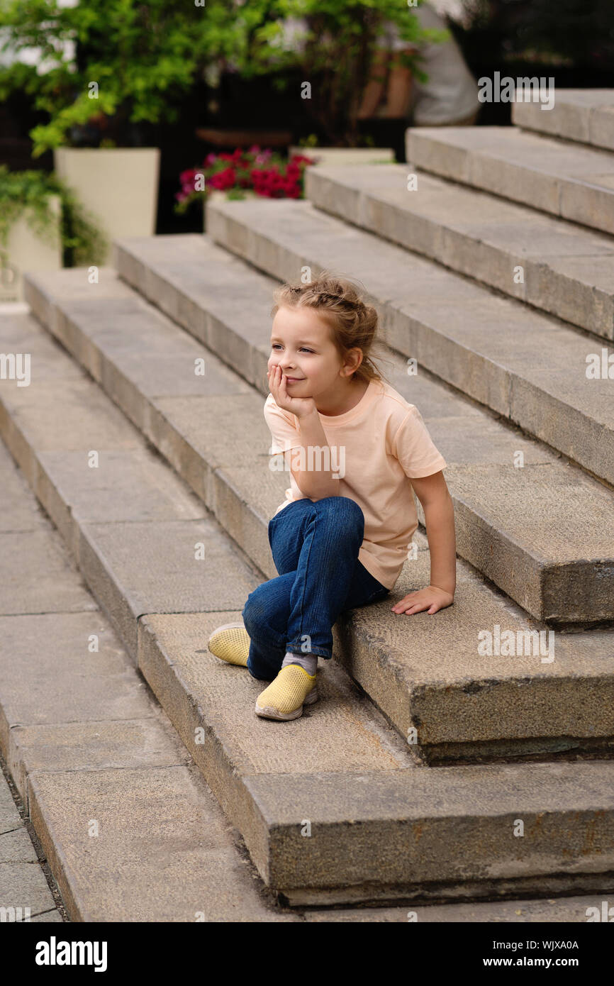 Cute Little Naughty Girl Walking Through The City Streets And Posing For The Camera Time Of
