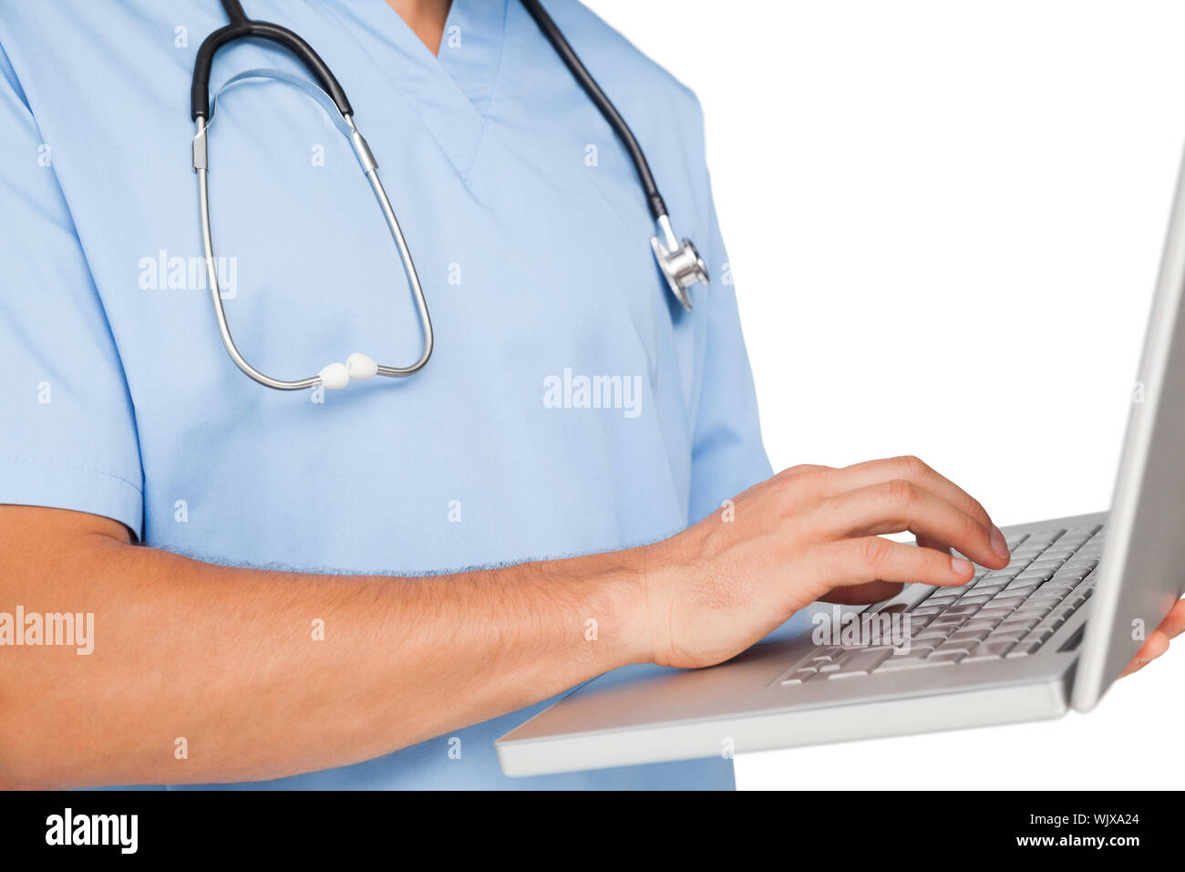 Close-up mid section of a male surgeon using laptop over white ...
