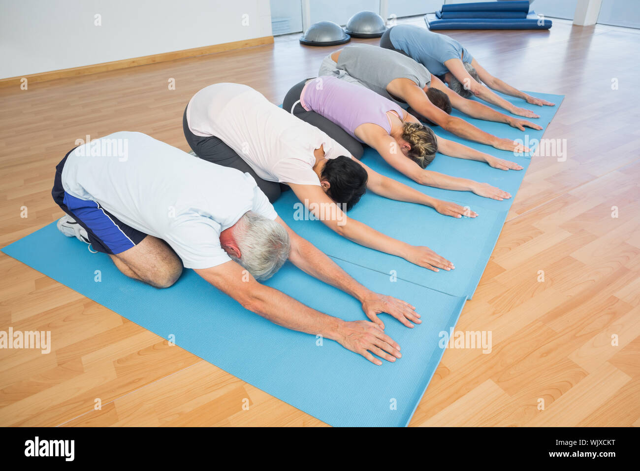 Fitness group bowing in row at the yoga class Stock Photo - Alamy