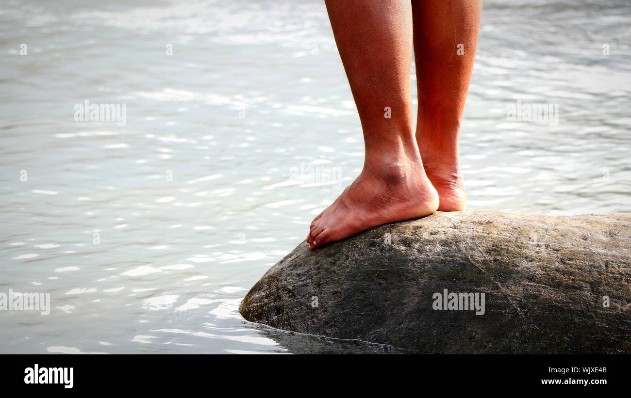 Man standing barefoot on rock hi-res stock photography and images - Alamy
