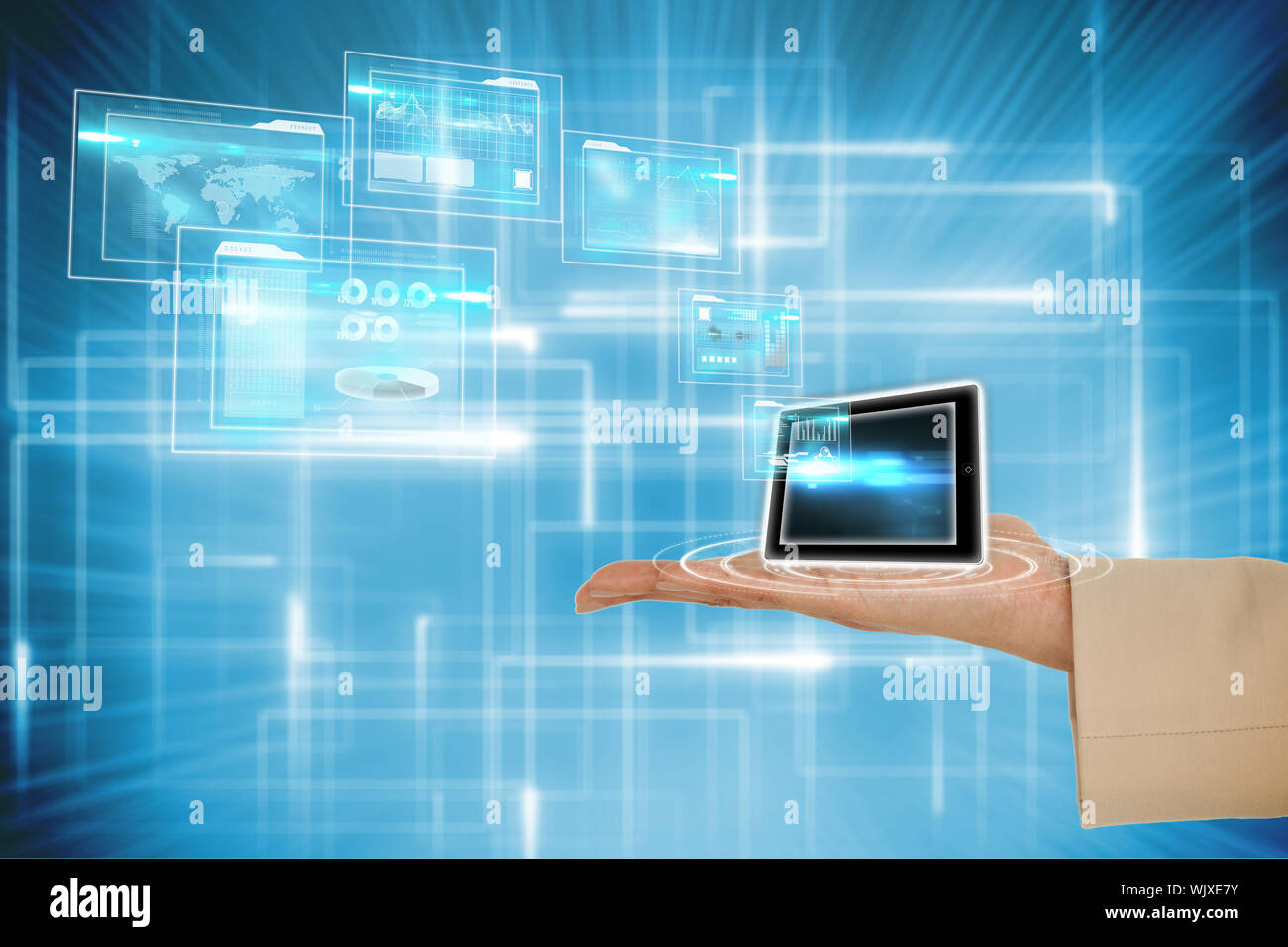Digital composite of hand presenting tablet and interfaces Stock Photo ...