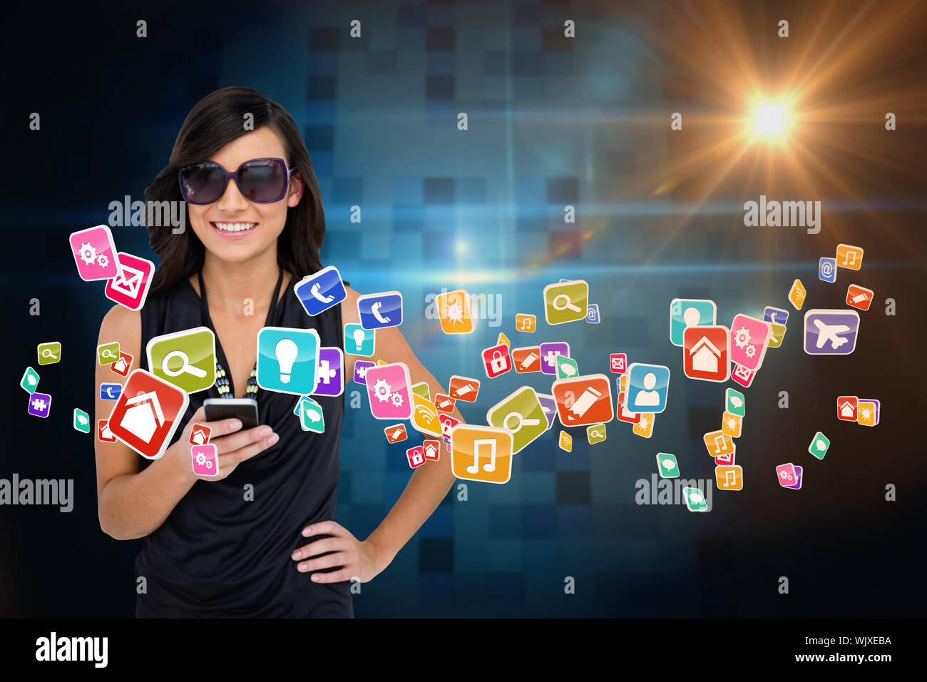 Digital composite of glamorous brunette using smartphone with app icons ...